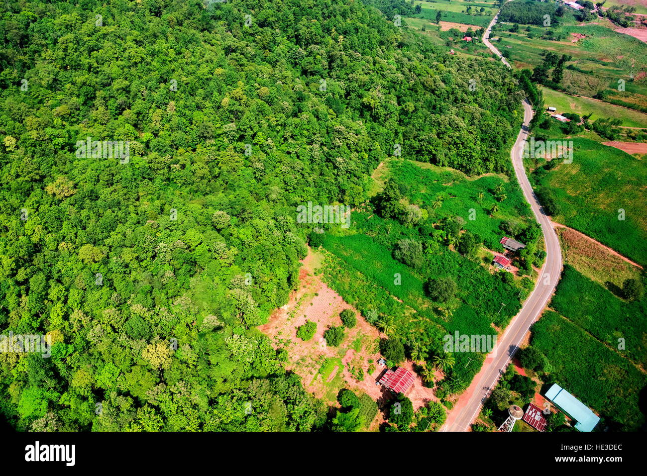 Aerial view over mountain road going through forest landscape Stock ...