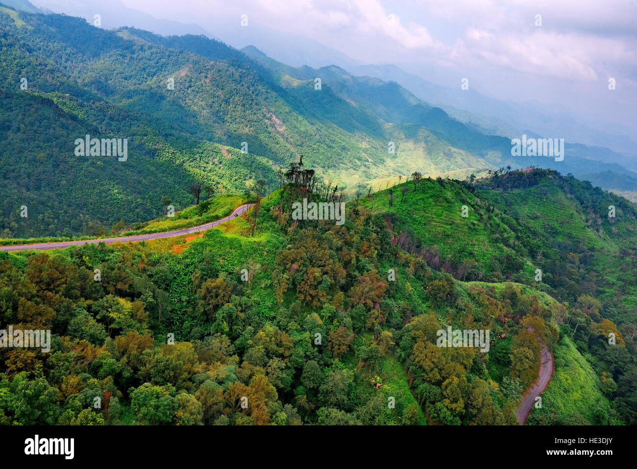 Aerial view over mountain road going through forest landscape Stock ...