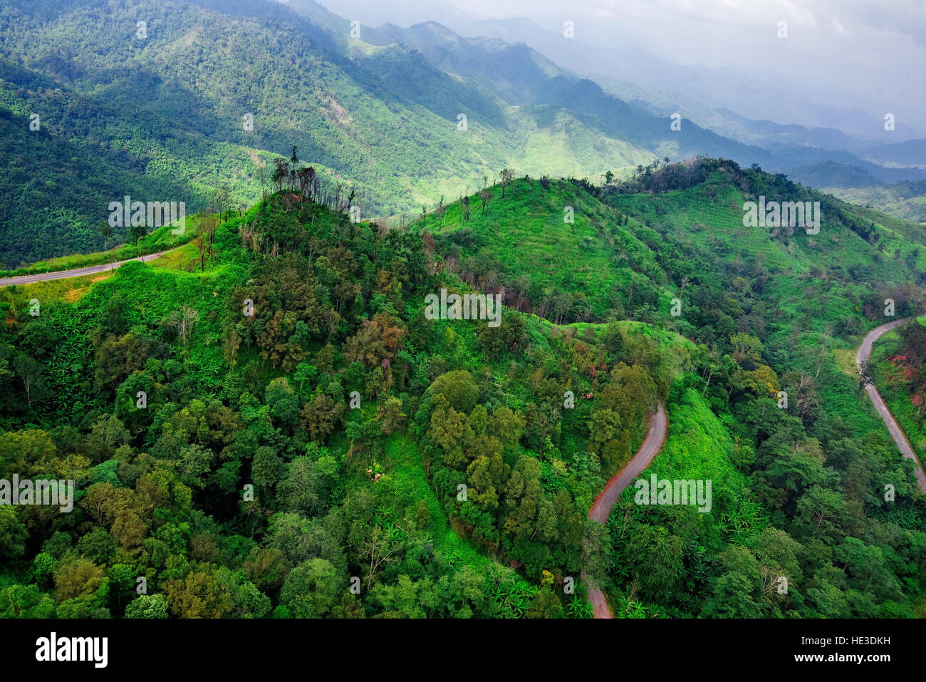 Aerial view over mountain road going through forest landscape Stock ...