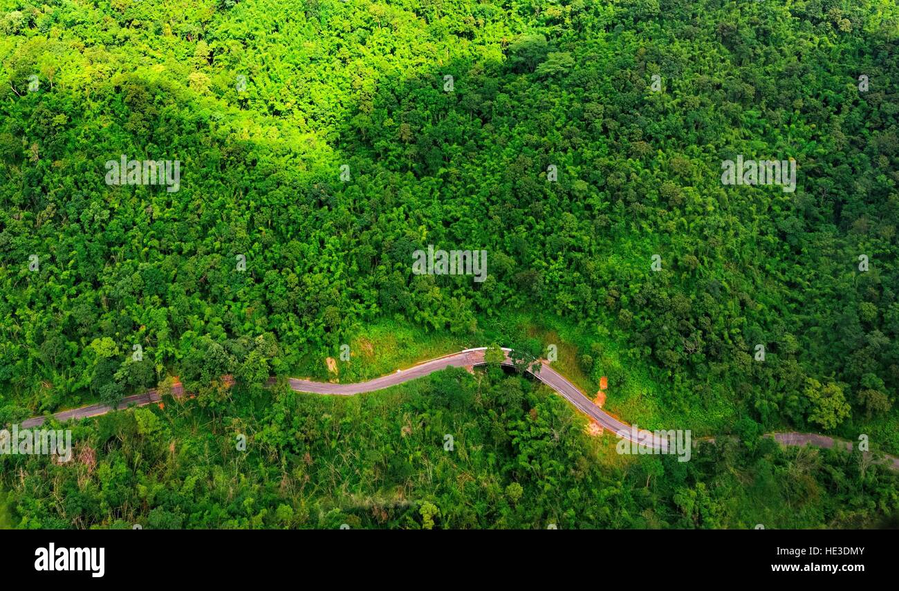 Aerial view over mountain road going through forest landscape Stock ...