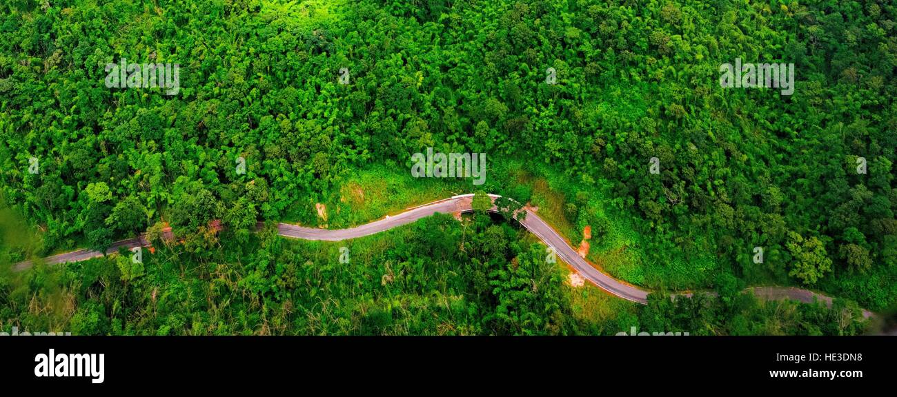 Aerial view over mountain road going through forest landscape Stock ...