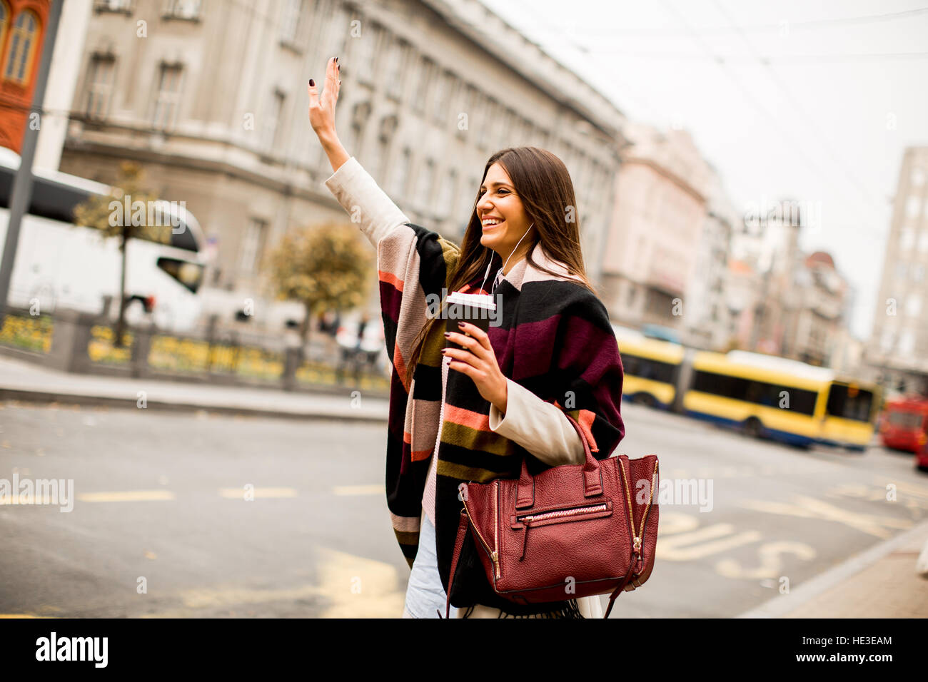 Businesswoman hailing a taxi hi-res stock photography and images - Alamy