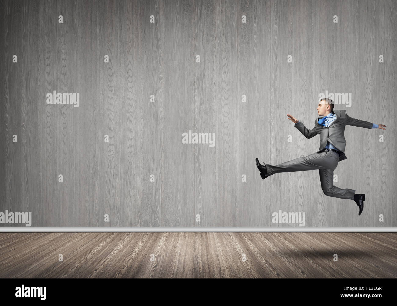 Businessman jumping high Stock Photo - Alamy