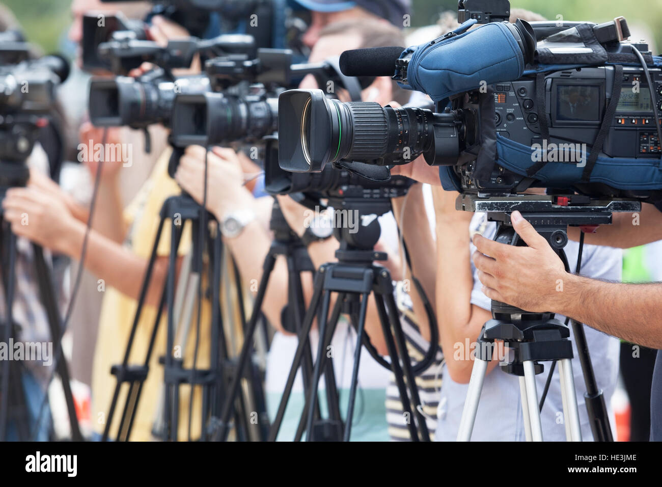 Video camera operators working at news conference Stock Photo - Alamy