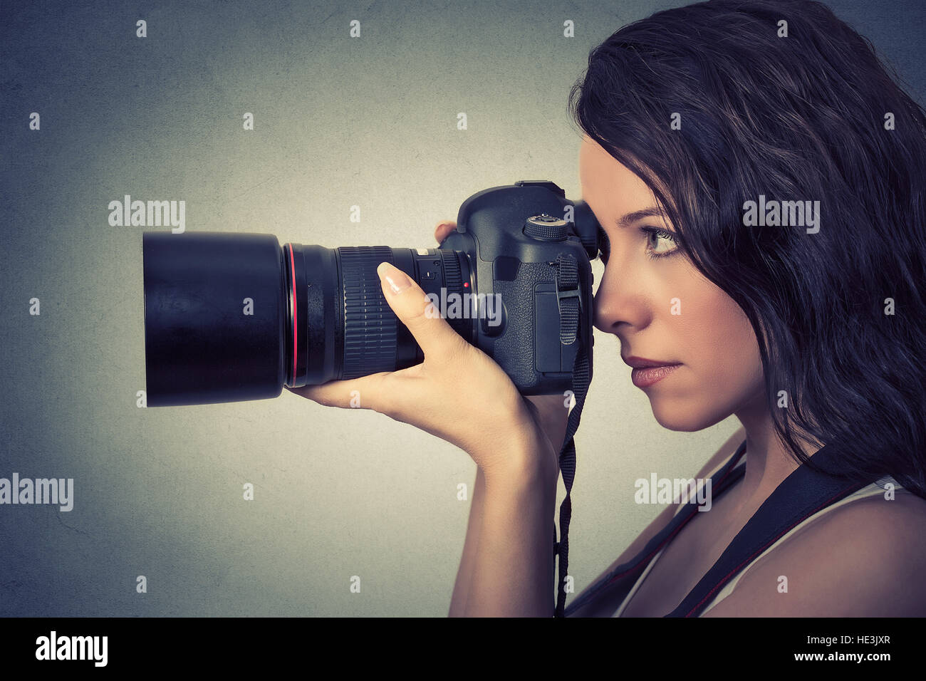 Side profile young woman taking pictures with professional camera Stock ...