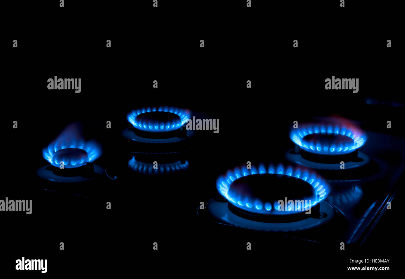 Natural gas burning a blue flames on black background Stock Photo - Alamy