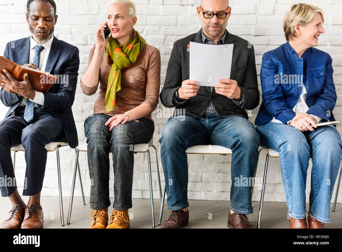 Group diverse men sitting hi-res stock photography and images - Alamy