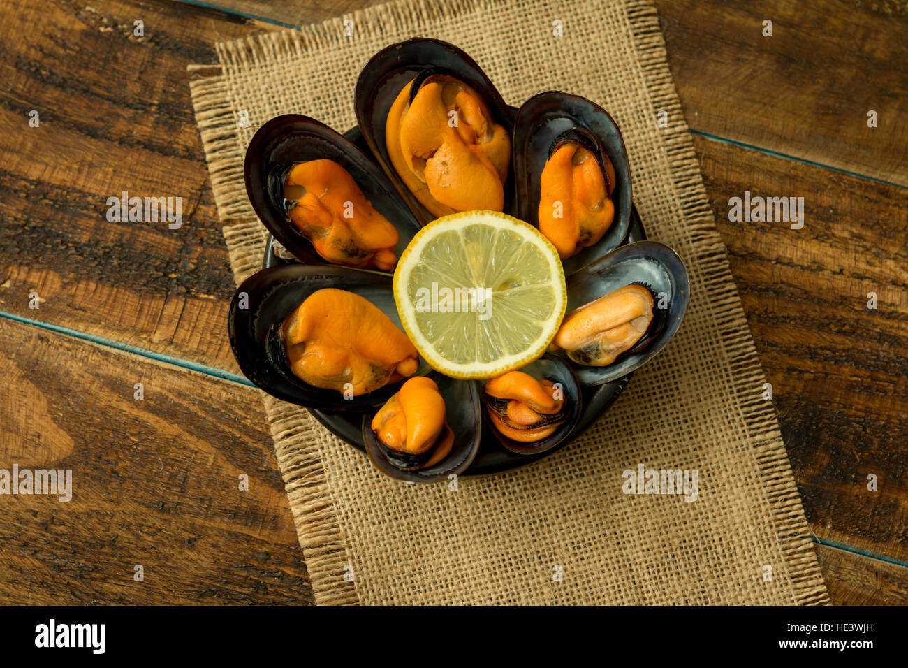 Delicius appetizer with natural mussels and lemon Stock Photo - Alamy