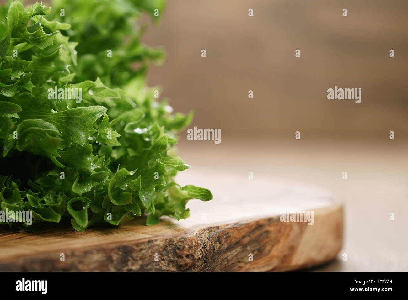 frisee lettuce close up leaves on wooden table Stock Photo - Alamy