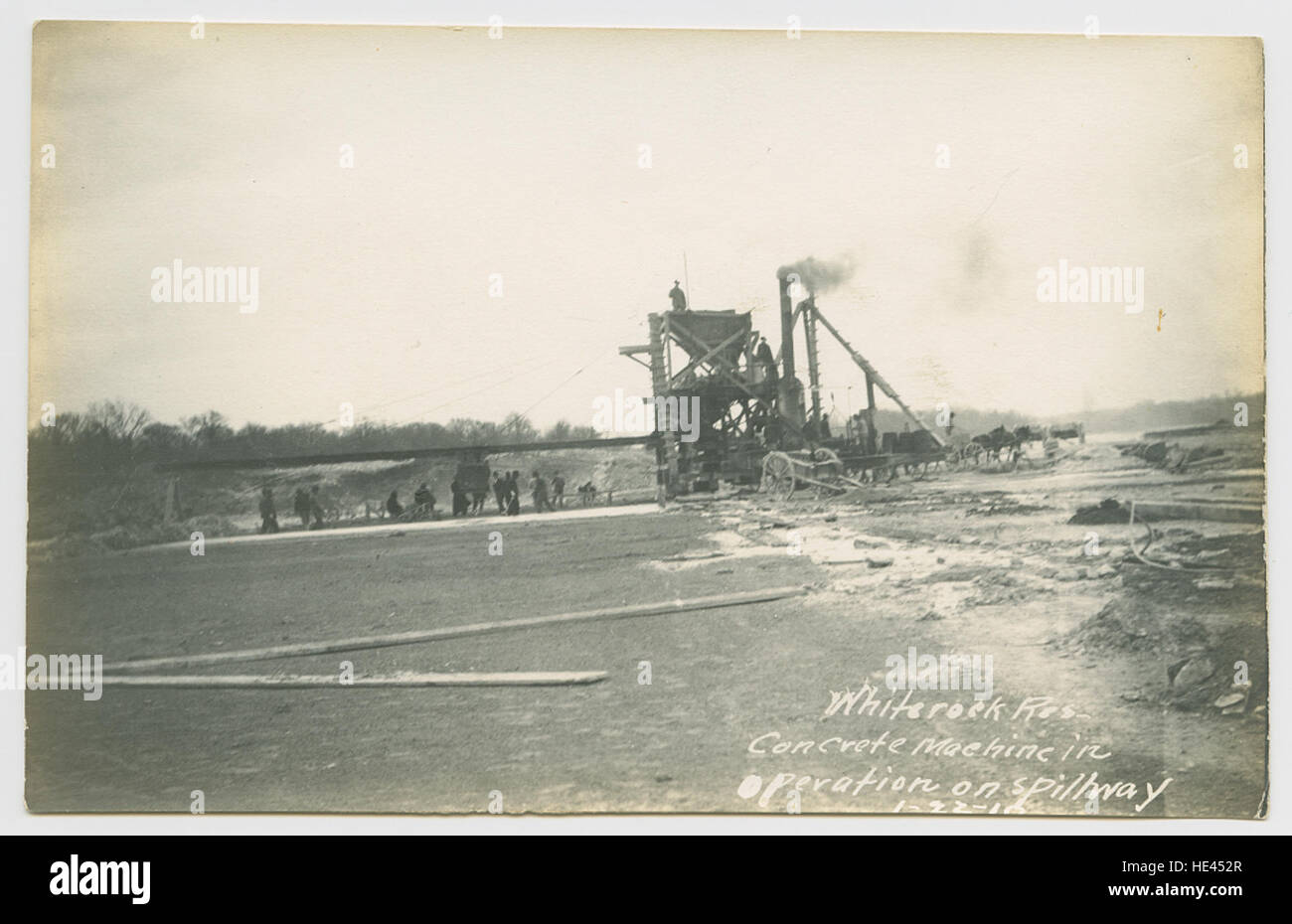 This historic image shows a concrete machine at work on the spillway of ...