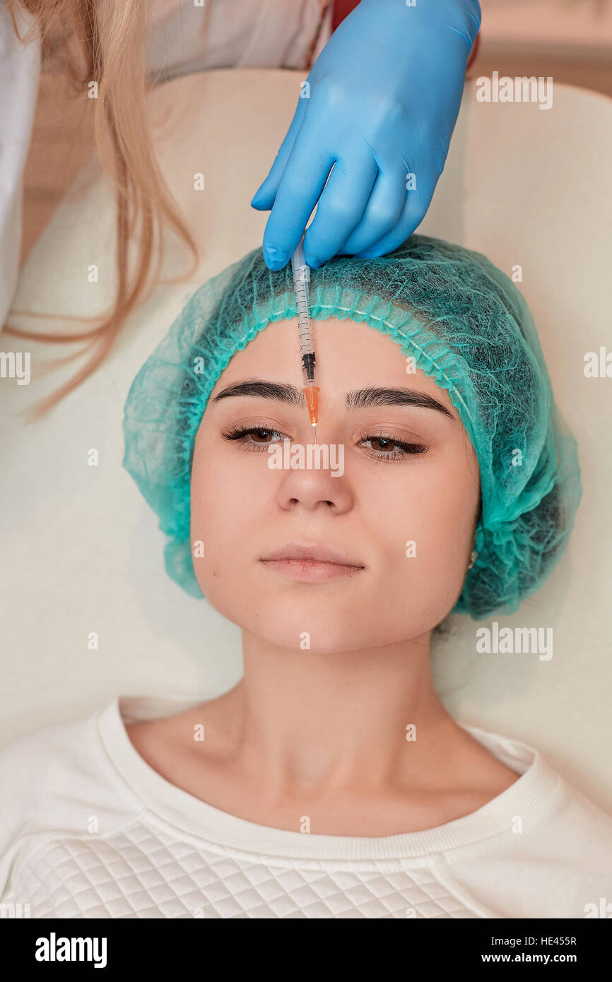 Woman receiving cosmetic injection through nose Stock Photo - Alamy