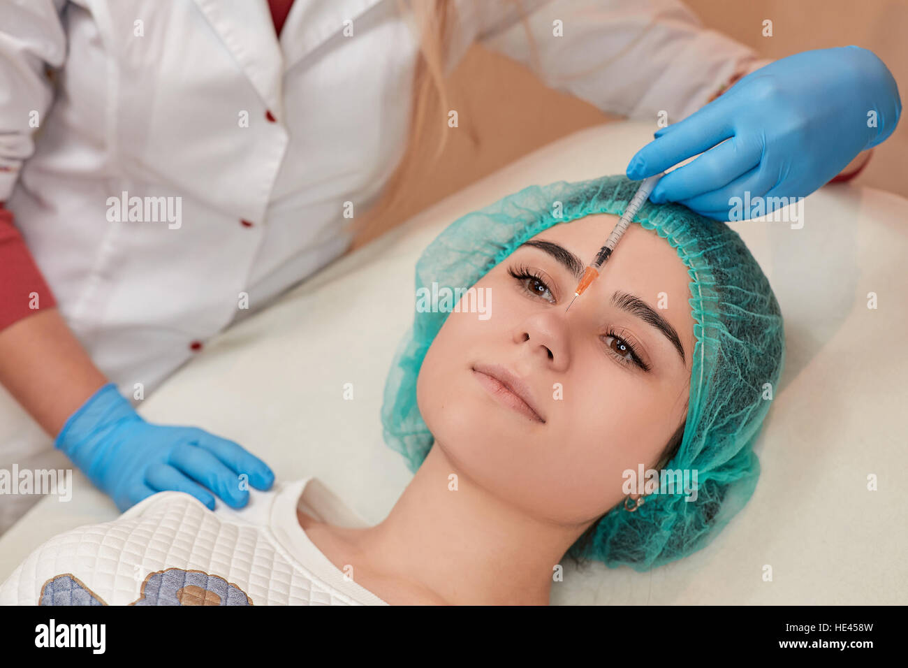Woman receiving cosmetic injection through nose Stock Photo - Alamy