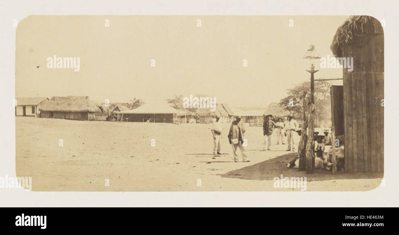 This image captures a rural street scene from a bygone era, offering a ...