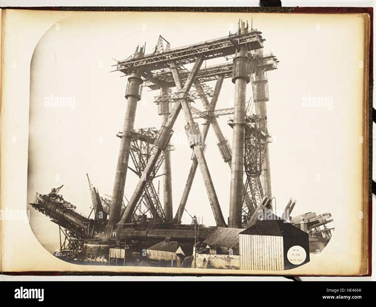 This historical image captures the construction of the Forth Bridge ...