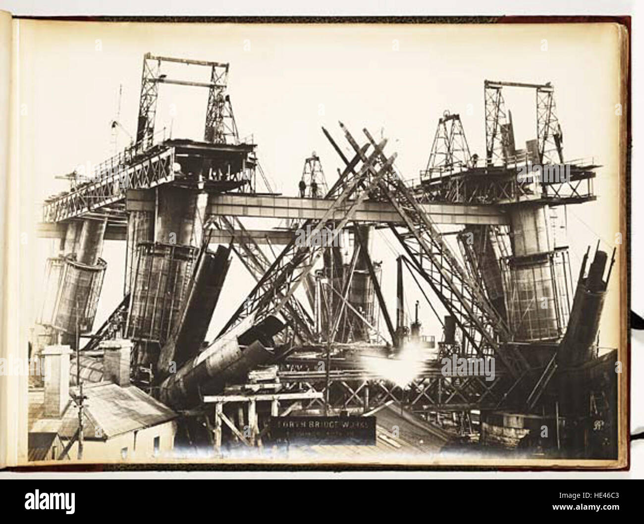 This image captures the construction of the Forth Bridge, specifically ...