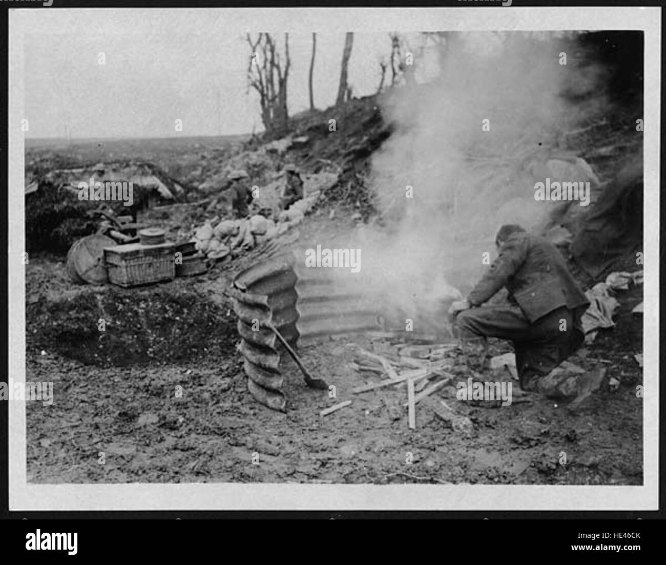 This historical image shows a cook preparing dinner for a military ...