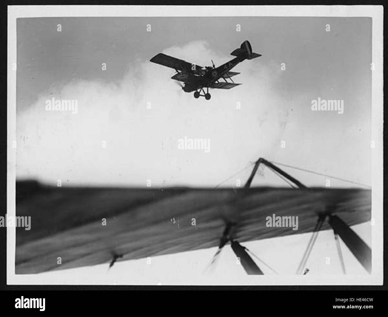 This historical image captures an aircraft flying over German lines ...