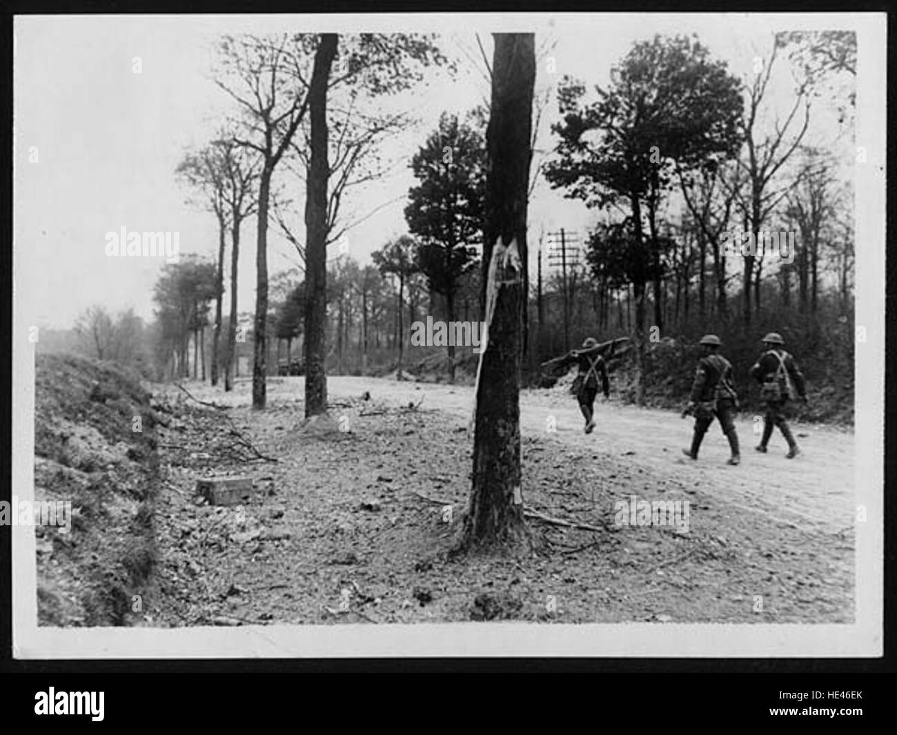 This historical image captures stretcher bearers rushing along a war ...
