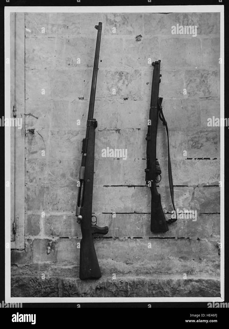 This historical image shows a German anti-tank rifle and a British ...