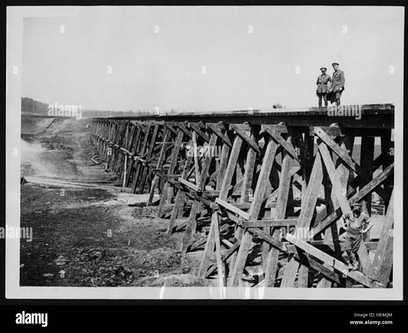 This historic image showcases the remarkable construction of a trestle ...