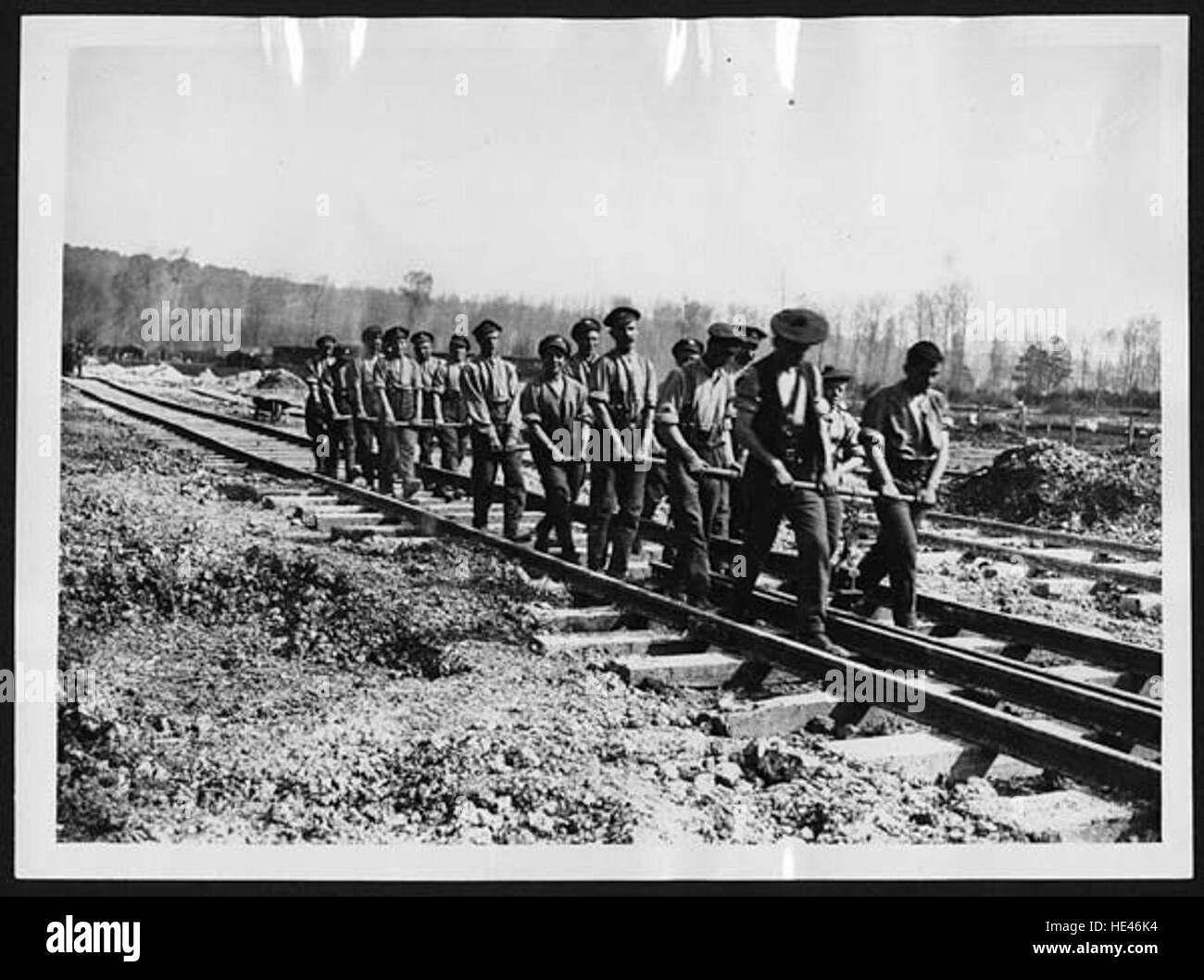 This image shows the process of laying down rails, a crucial part of ...