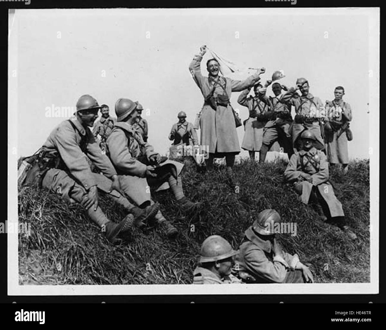 A historical photograph showing a French soldier entertaining his ...