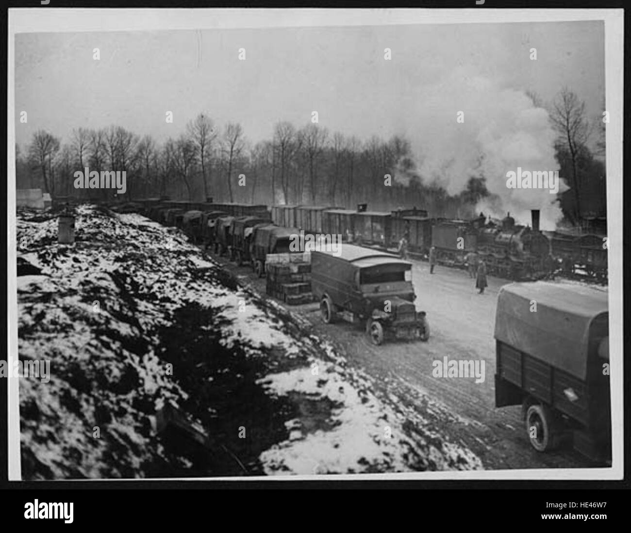 A historic image depicting a supply train arriving at a railhead ...
