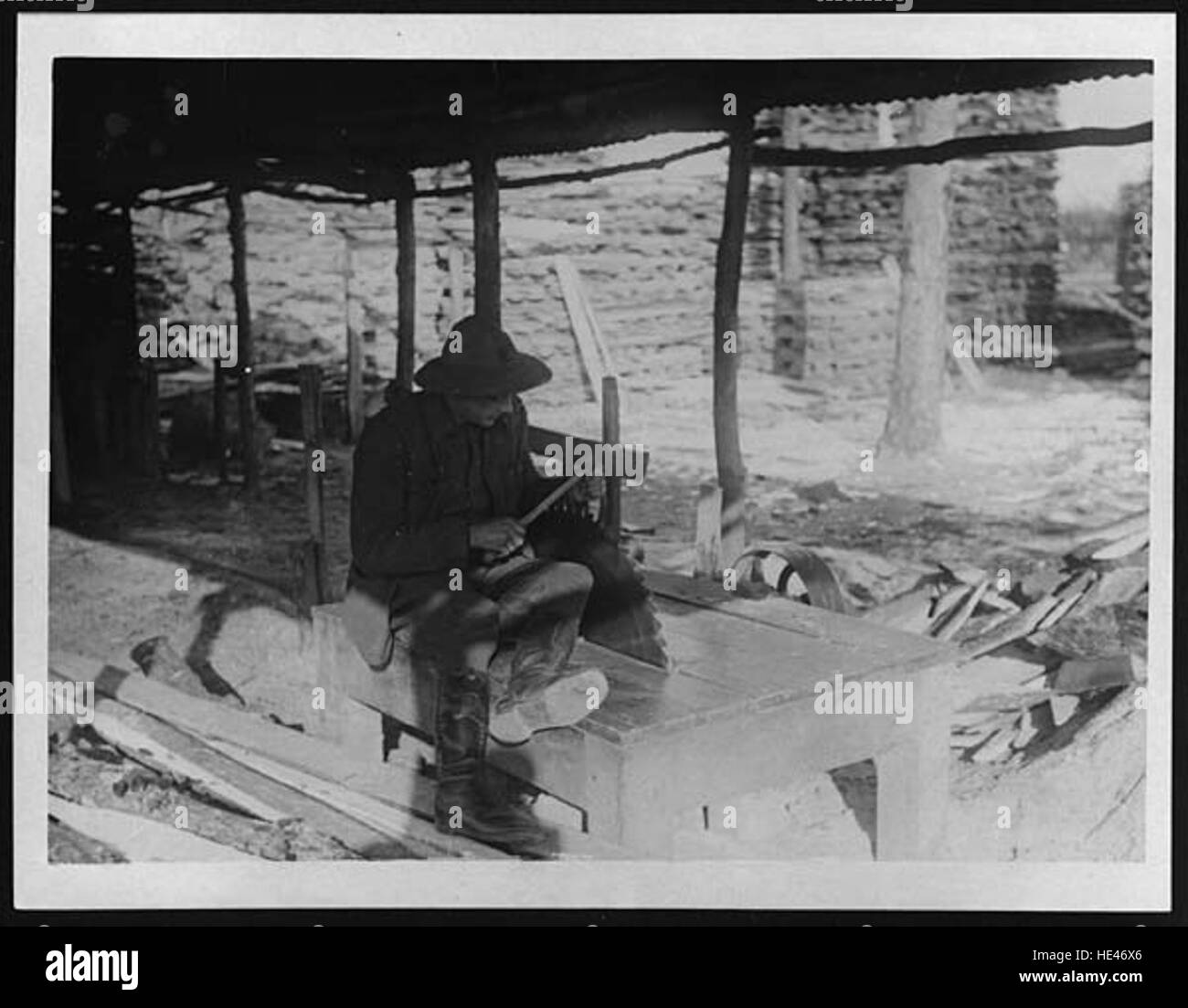 This historic image depicts a man setting his saw, a common task in ...