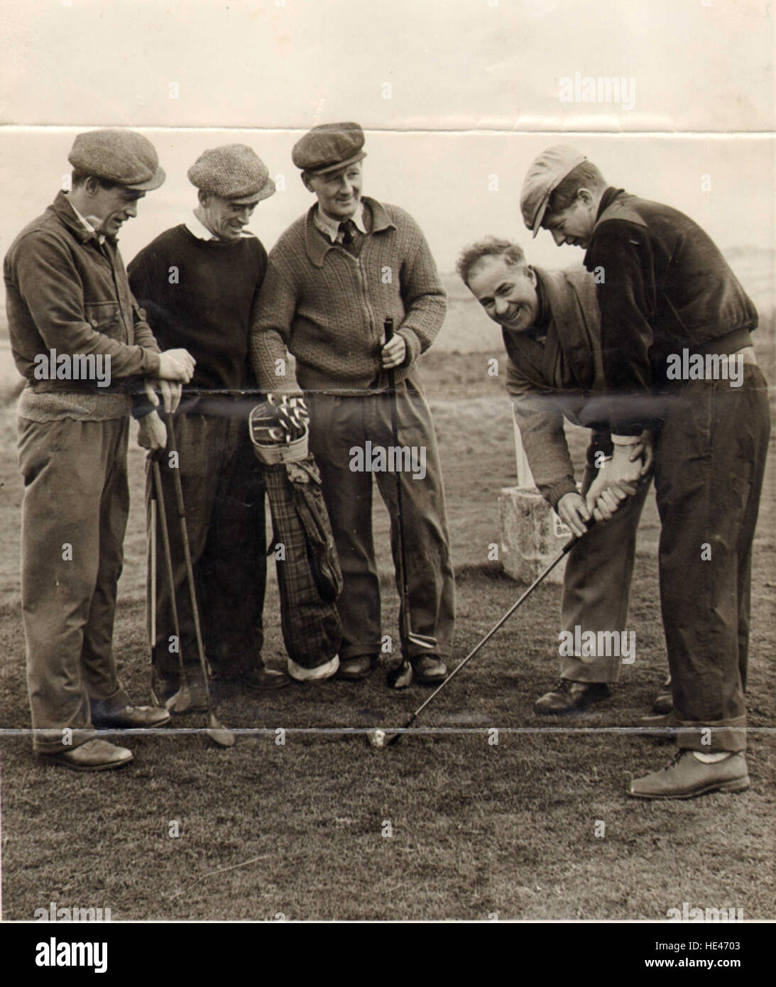 This historical image captures men playing golf, showcasing a moment ...