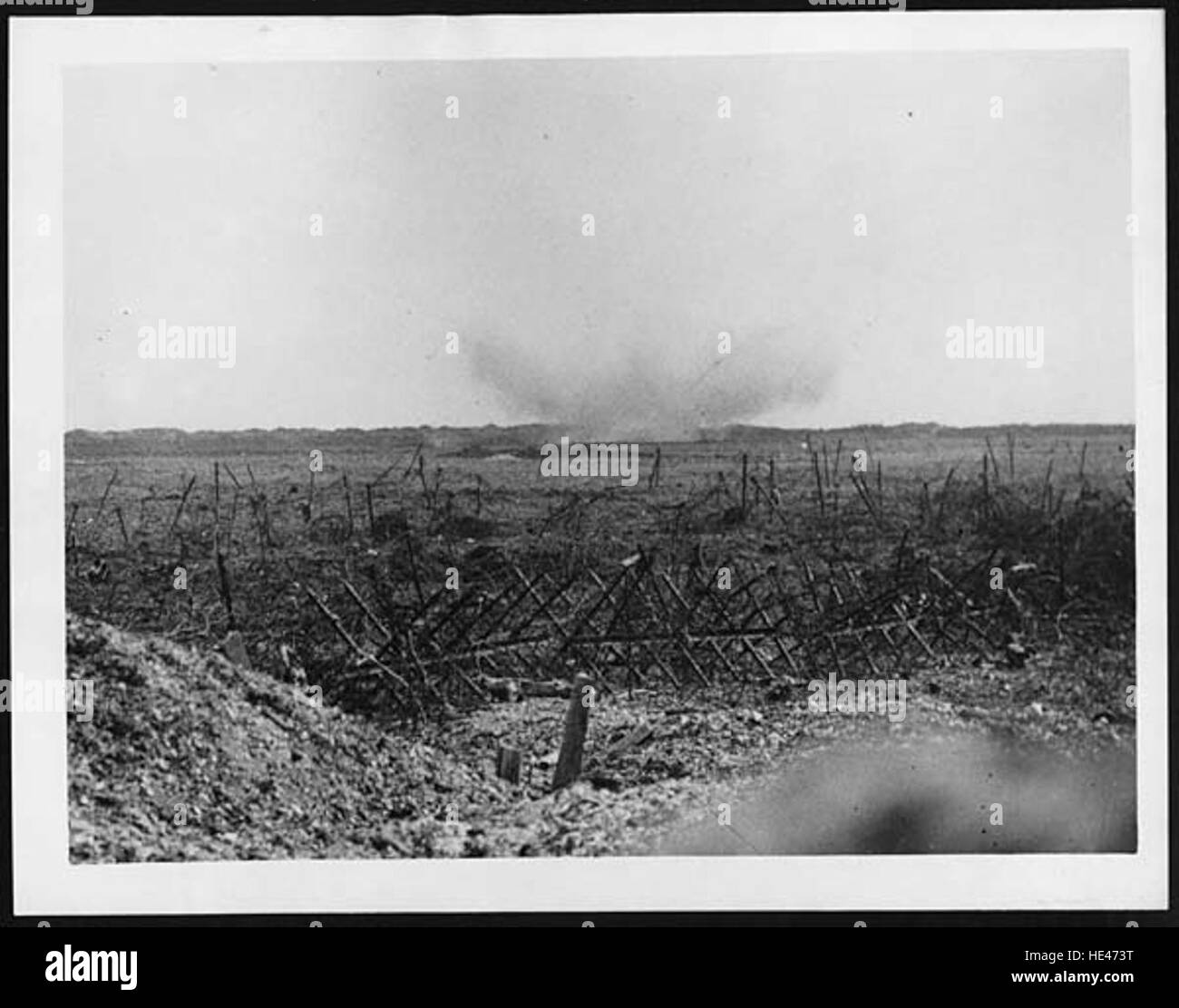 This historical image depicts shell bursting on the Boche line, a ...