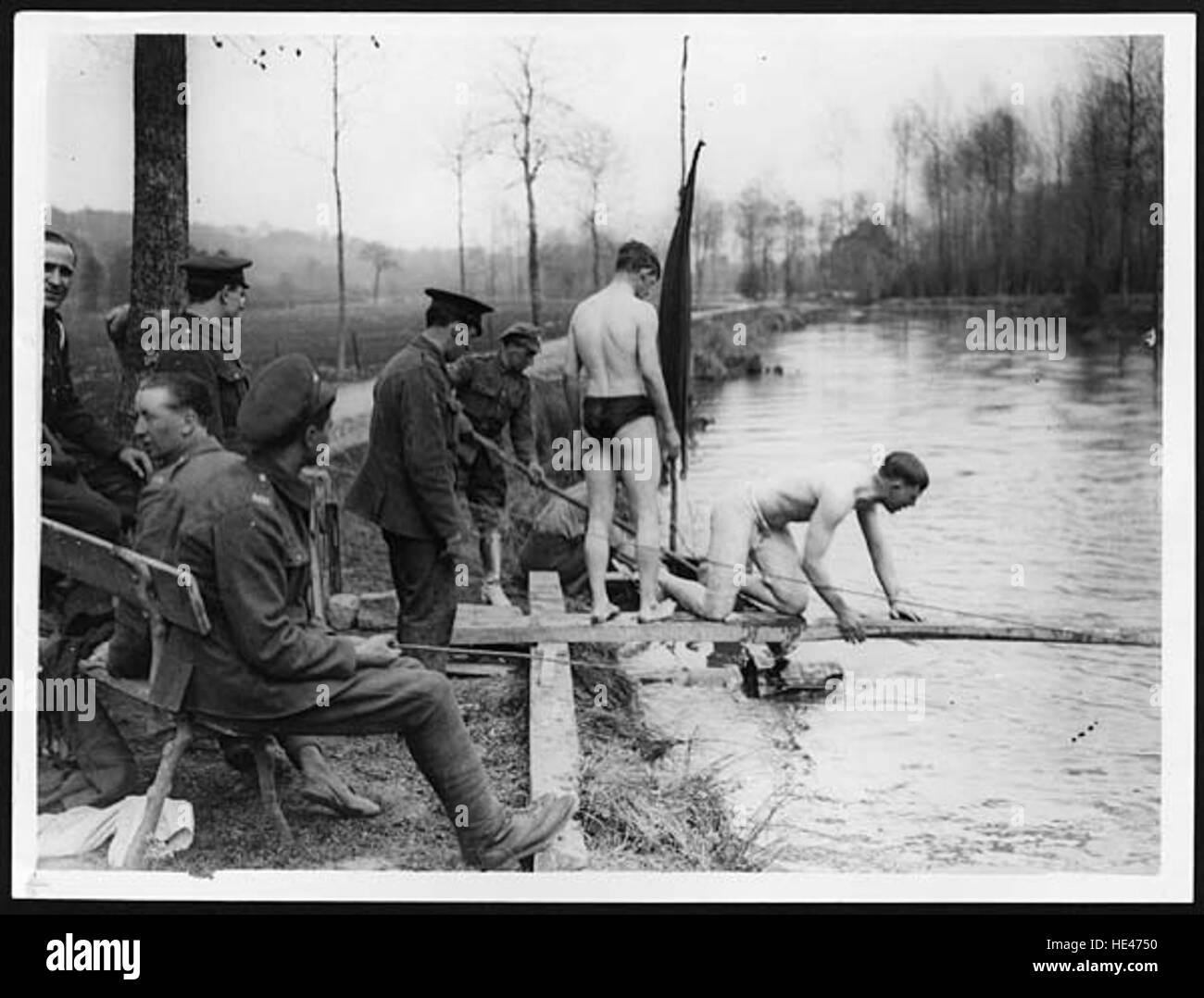 This vintage image depicts the testing of a homemade springboard, a ...
