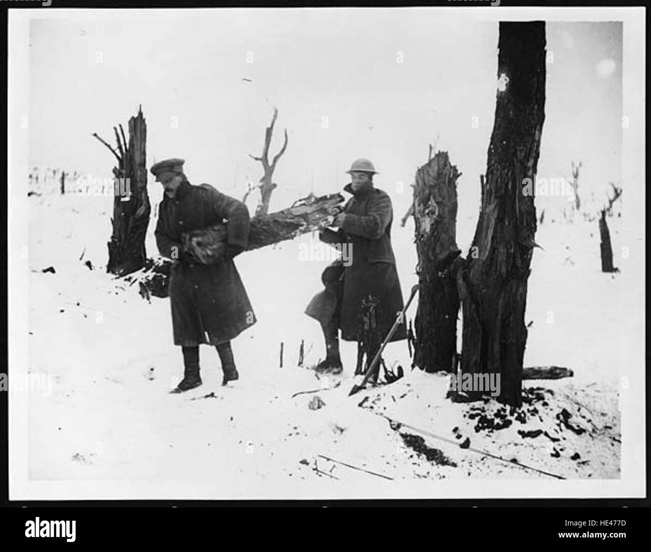 This historical image depicts individuals bringing in a log for a ...