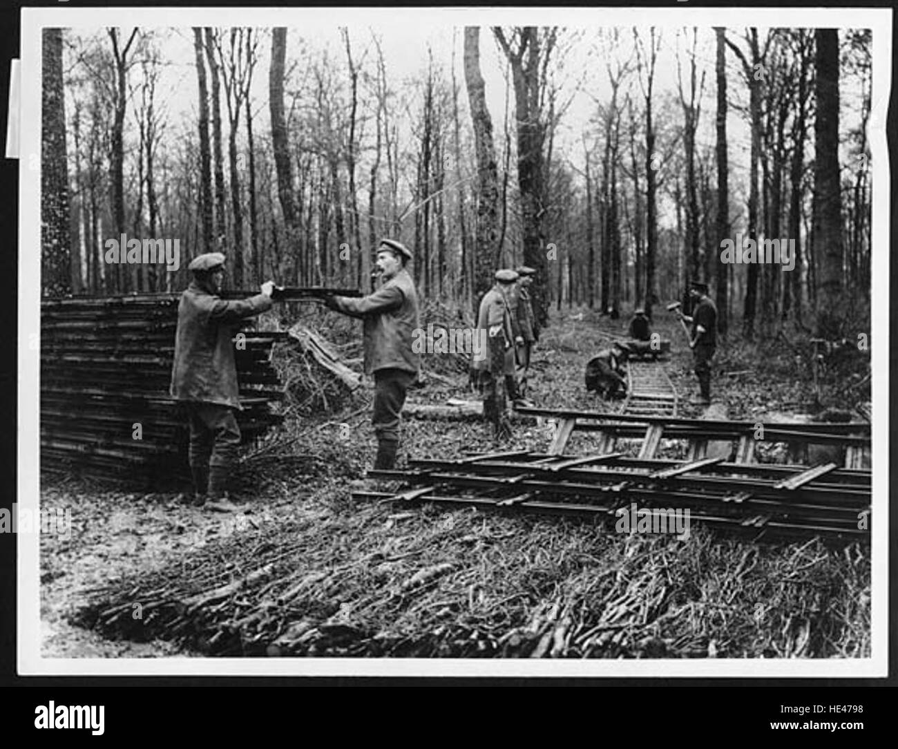 An old photograph depicting workers laying down a light railway for ...