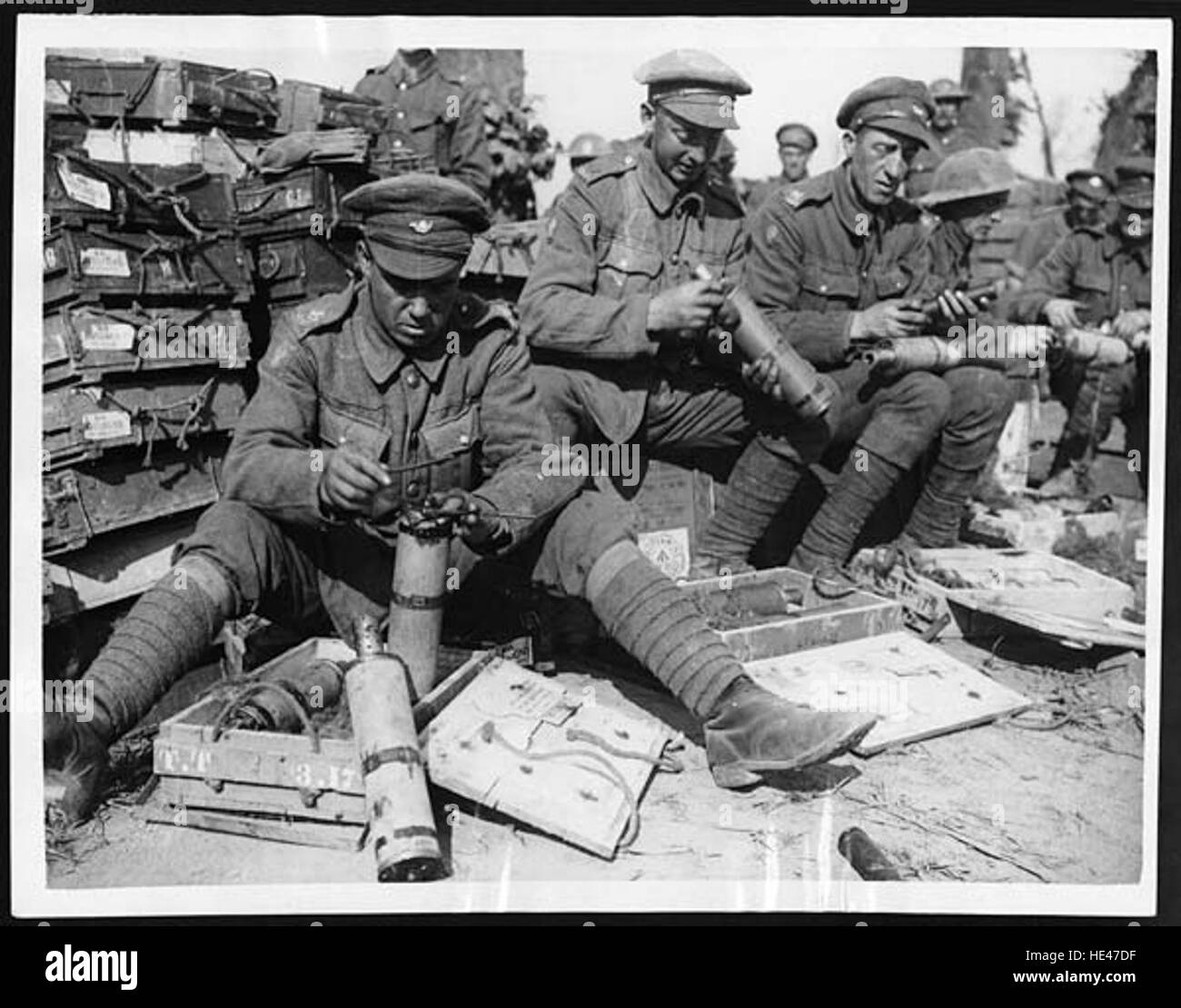 This historical image shows soldiers fusing Stokes trench mortar shells ...