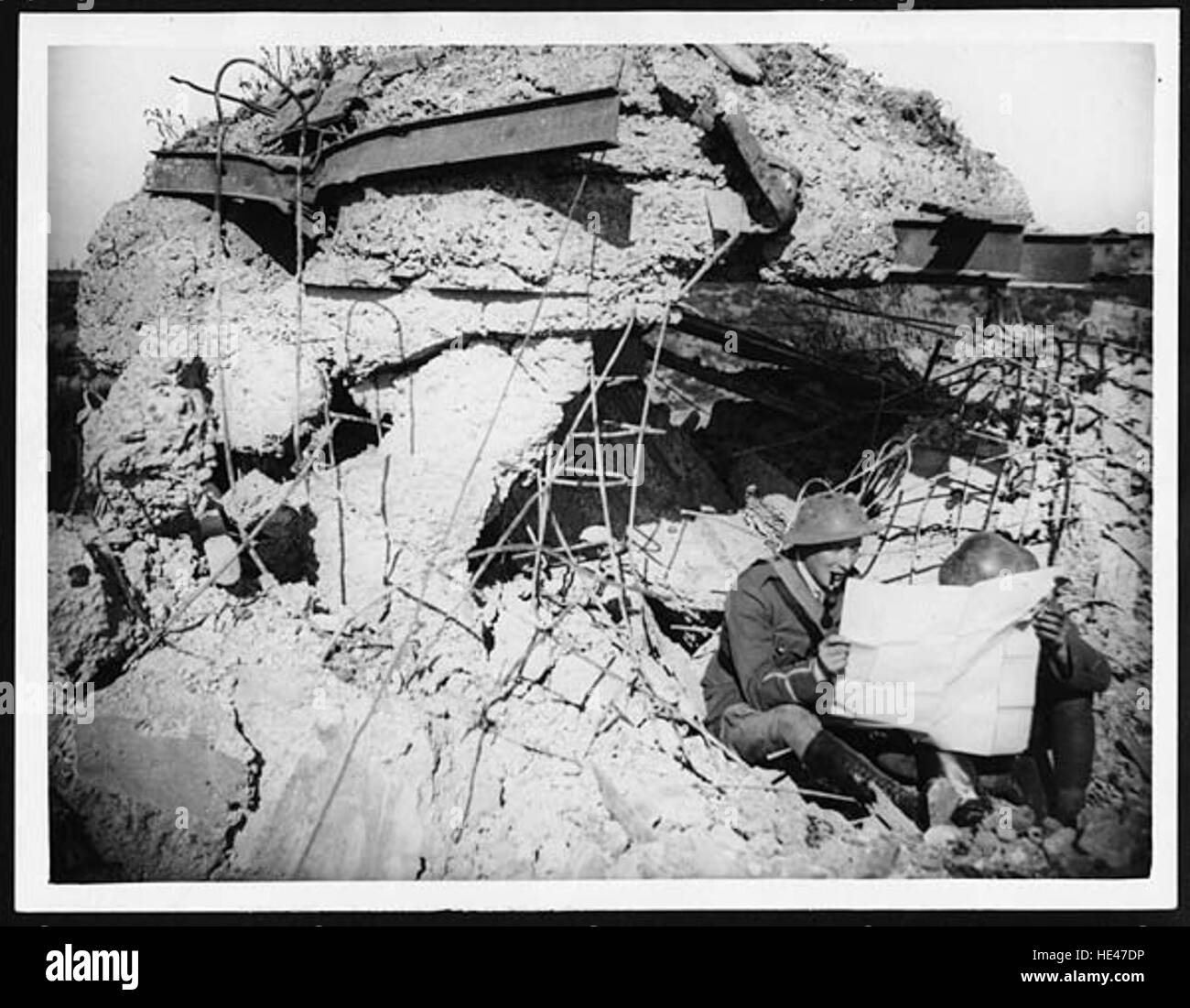 This historical photograph depicts a German officer studying a map ...