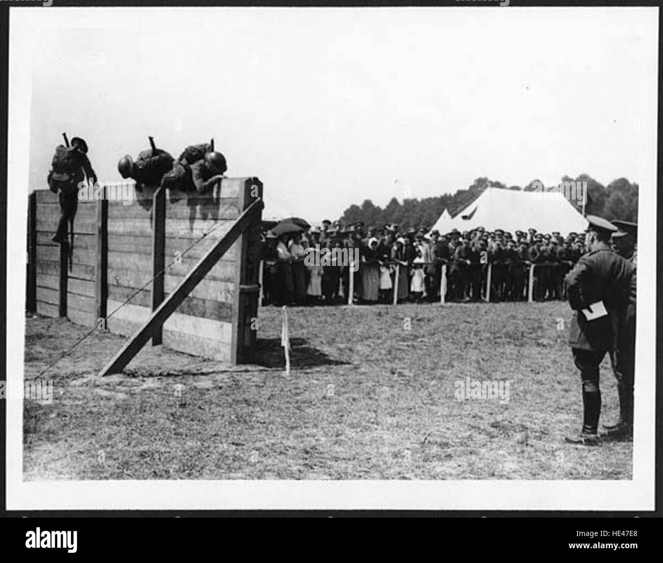 This historical image depicts a full group of infantrymen going over a ...
