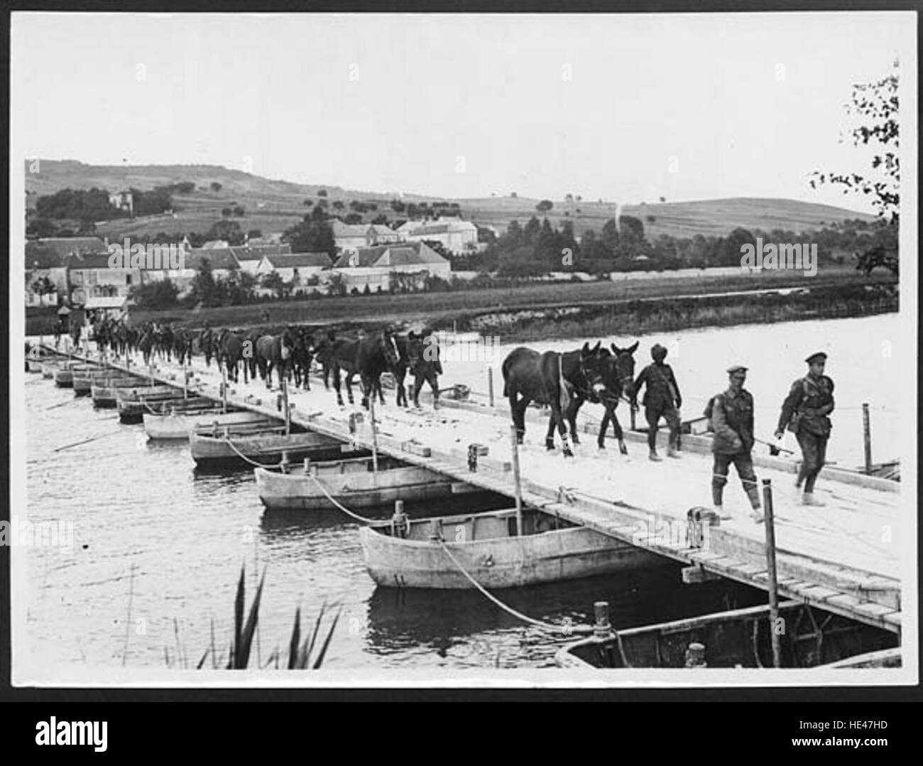 This historical image shows British transport crossing a pontoon bridge ...