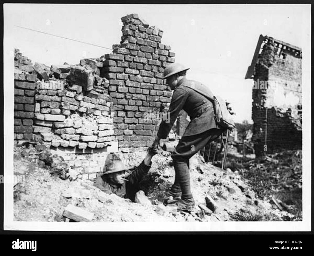 This vintage image depicts two soldiers helping each other, symbolizing ...