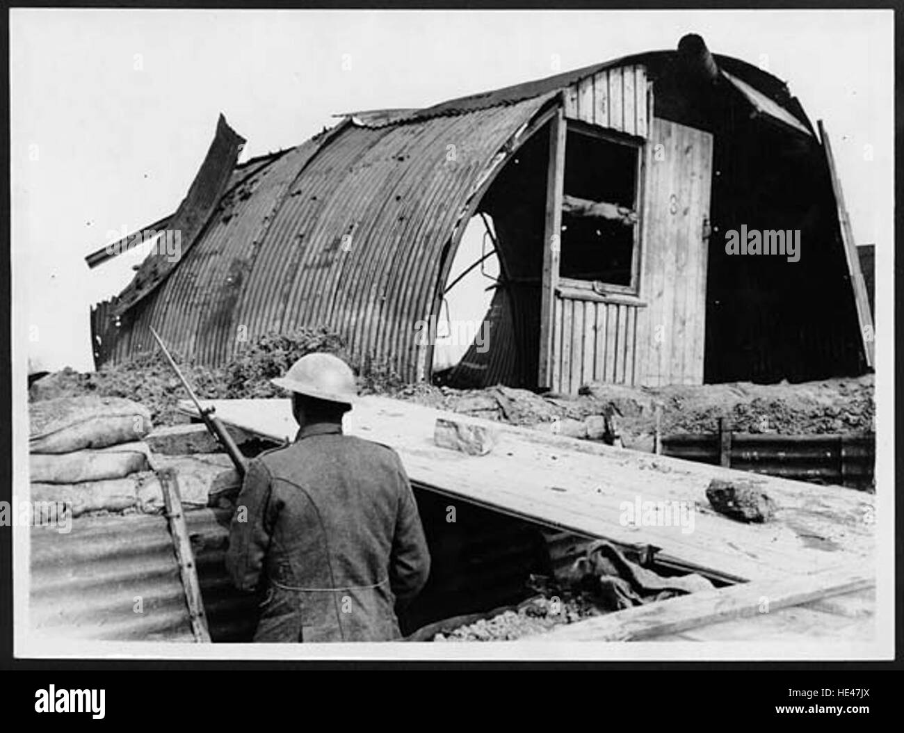 This historical photograph shows a sentry standing at the front line in ...