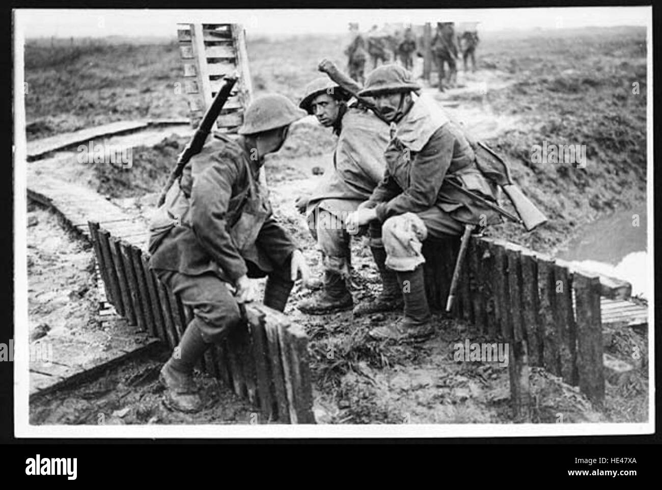 This historical image shows two Irish Guardsmen laying down duck-boards ...