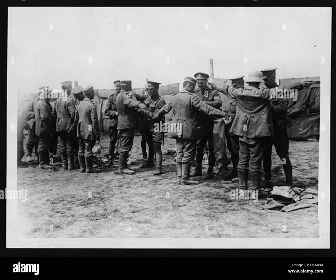 This historical image shows soldiers searching prisoners after a ...