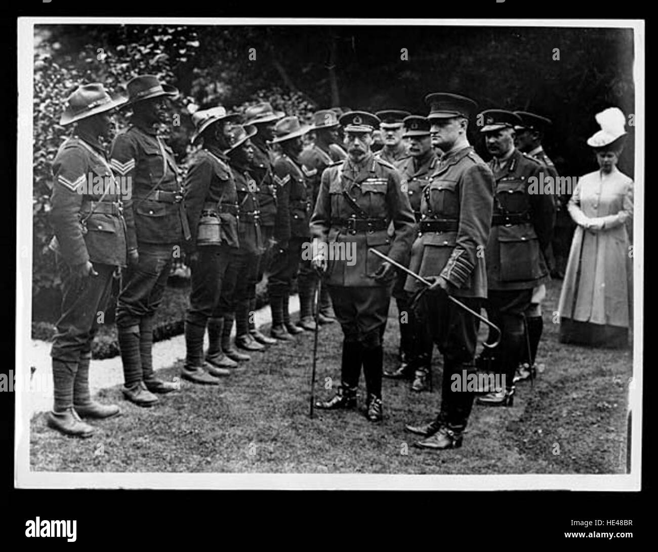 This historical photograph depicts a king inspecting the SAN (South ...