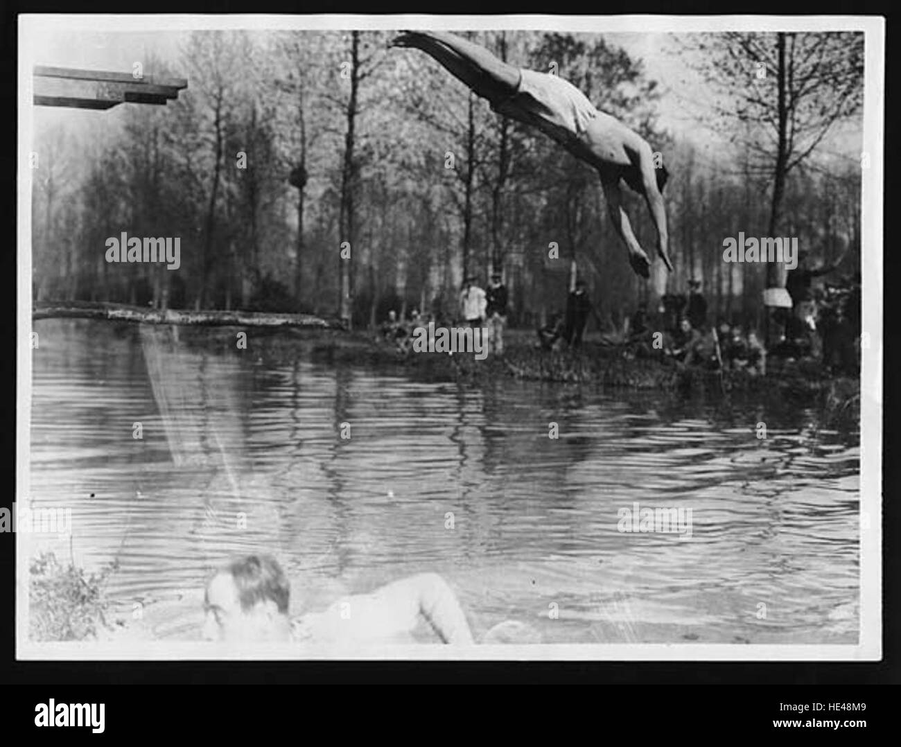 This image captures a historic diving competition, showcasing athletes ...