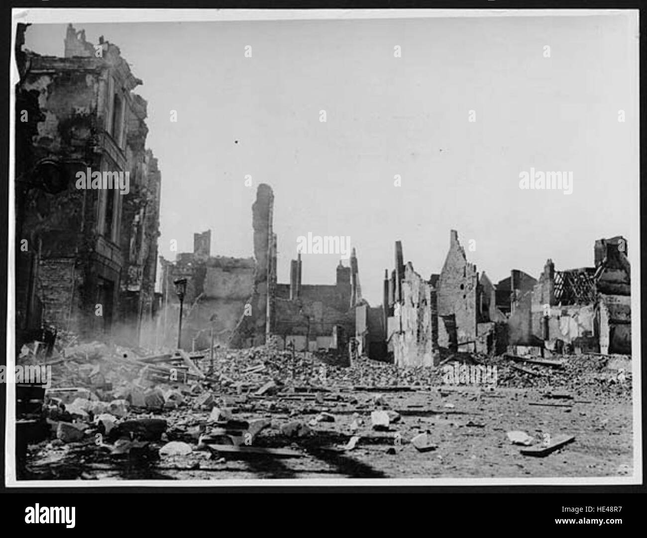 This historical image captures a view of the Grand Place in Bethune ...
