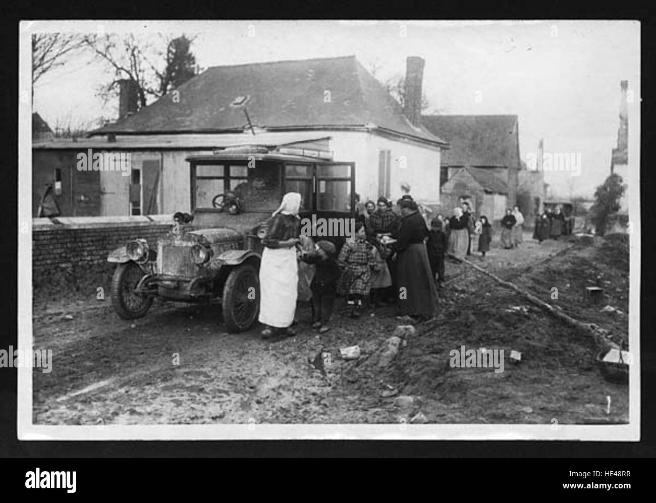 This historic image shows occupants of a British motor car stopping at ...