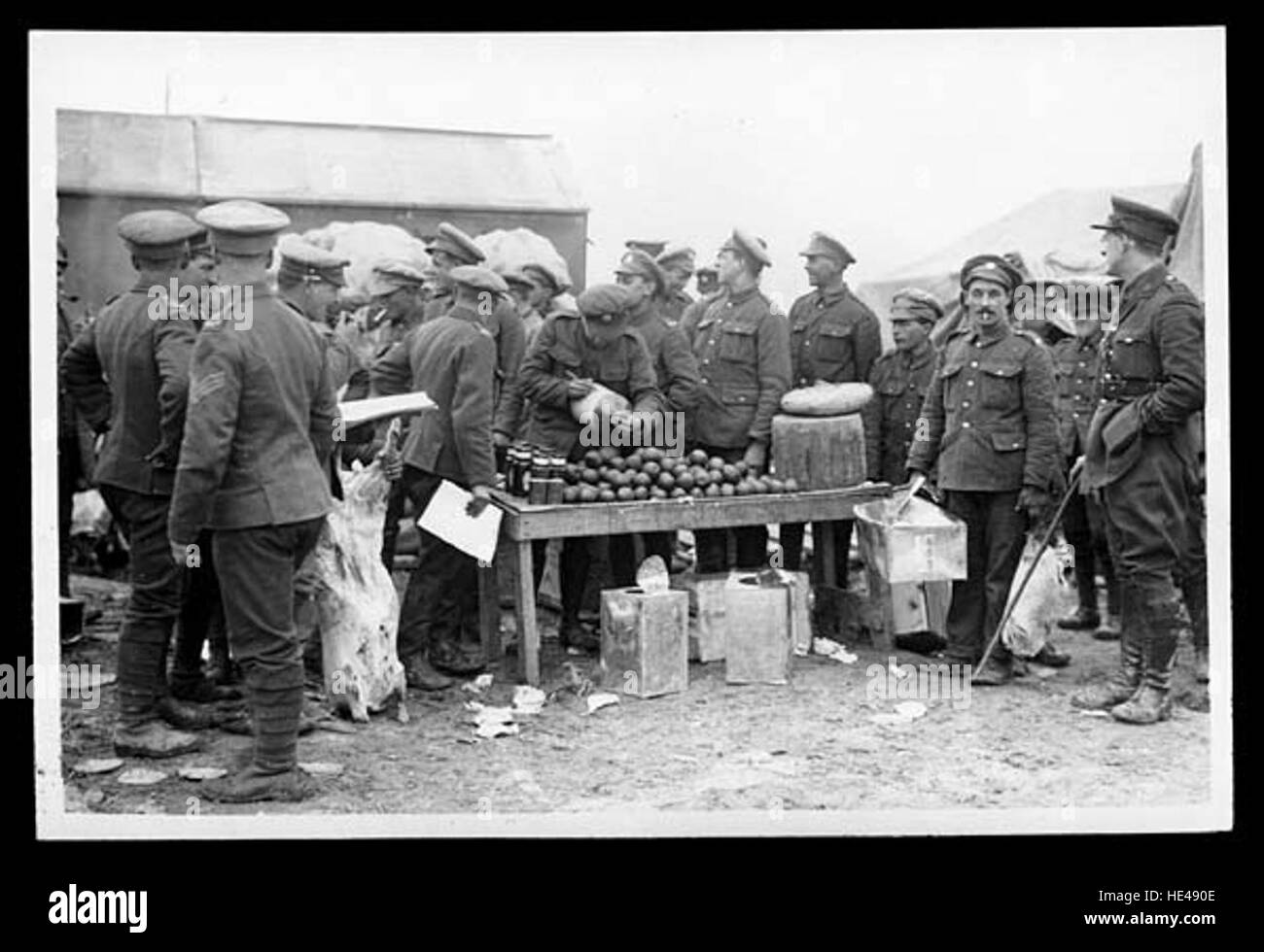 A historic image depicting soldiers drawing rations during a war. The ...