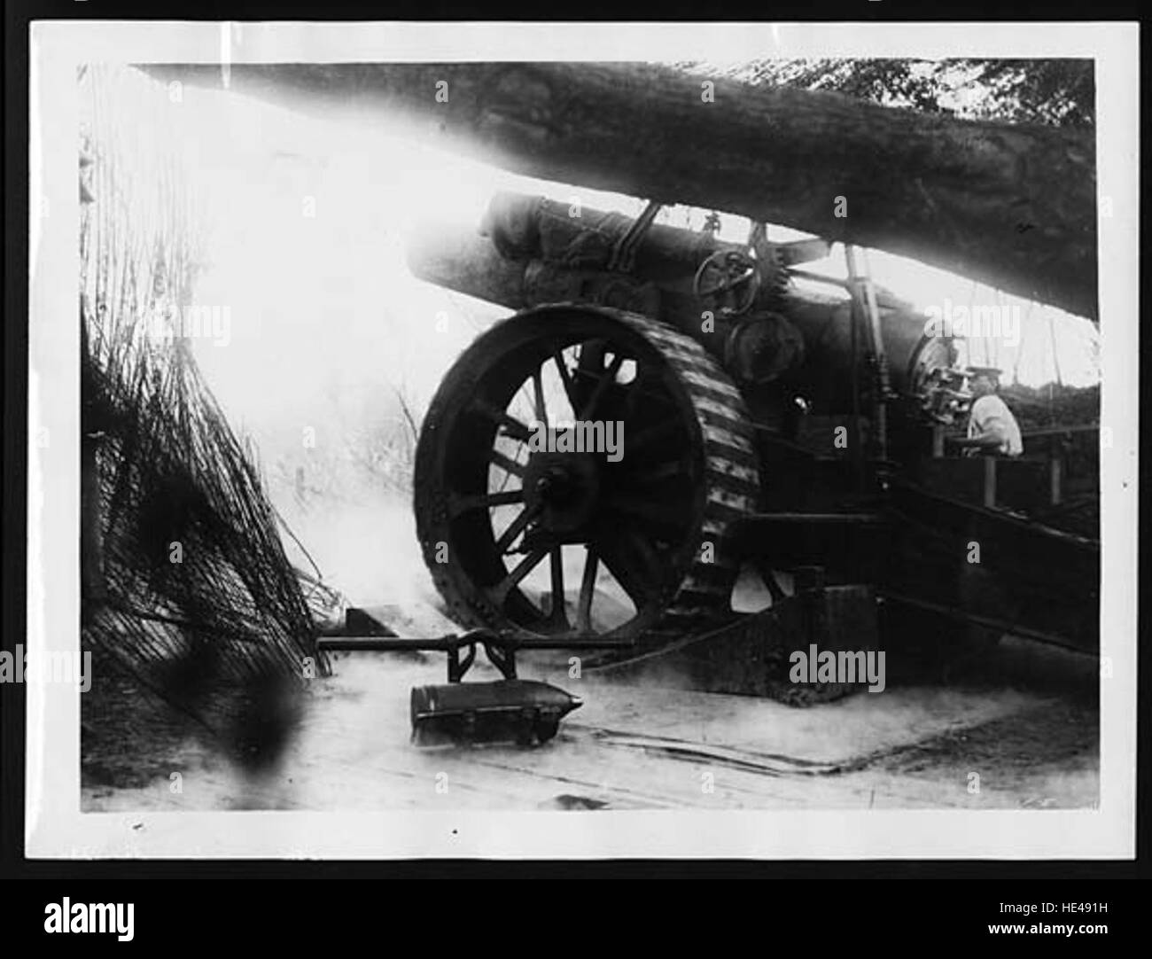This image captures the powerful firing of a howitzer, an iconic piece ...