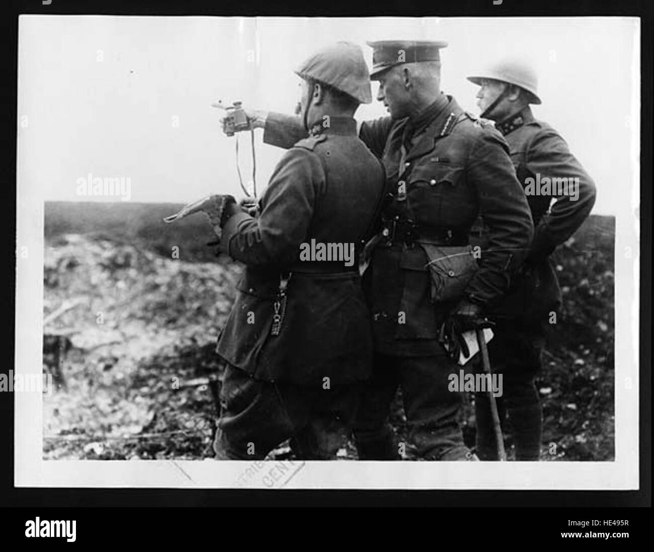 This historical image shows a Brigadier General pointing to the spot ...