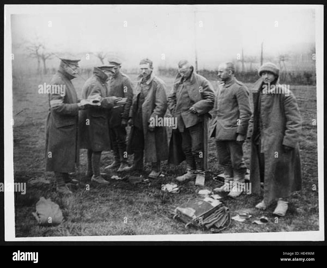 This historic image depicts soldiers searching newly captured German ...