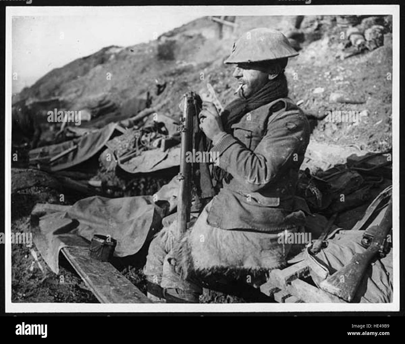 This vintage image depicts a soldier named Tommy cleaning his rifle ...